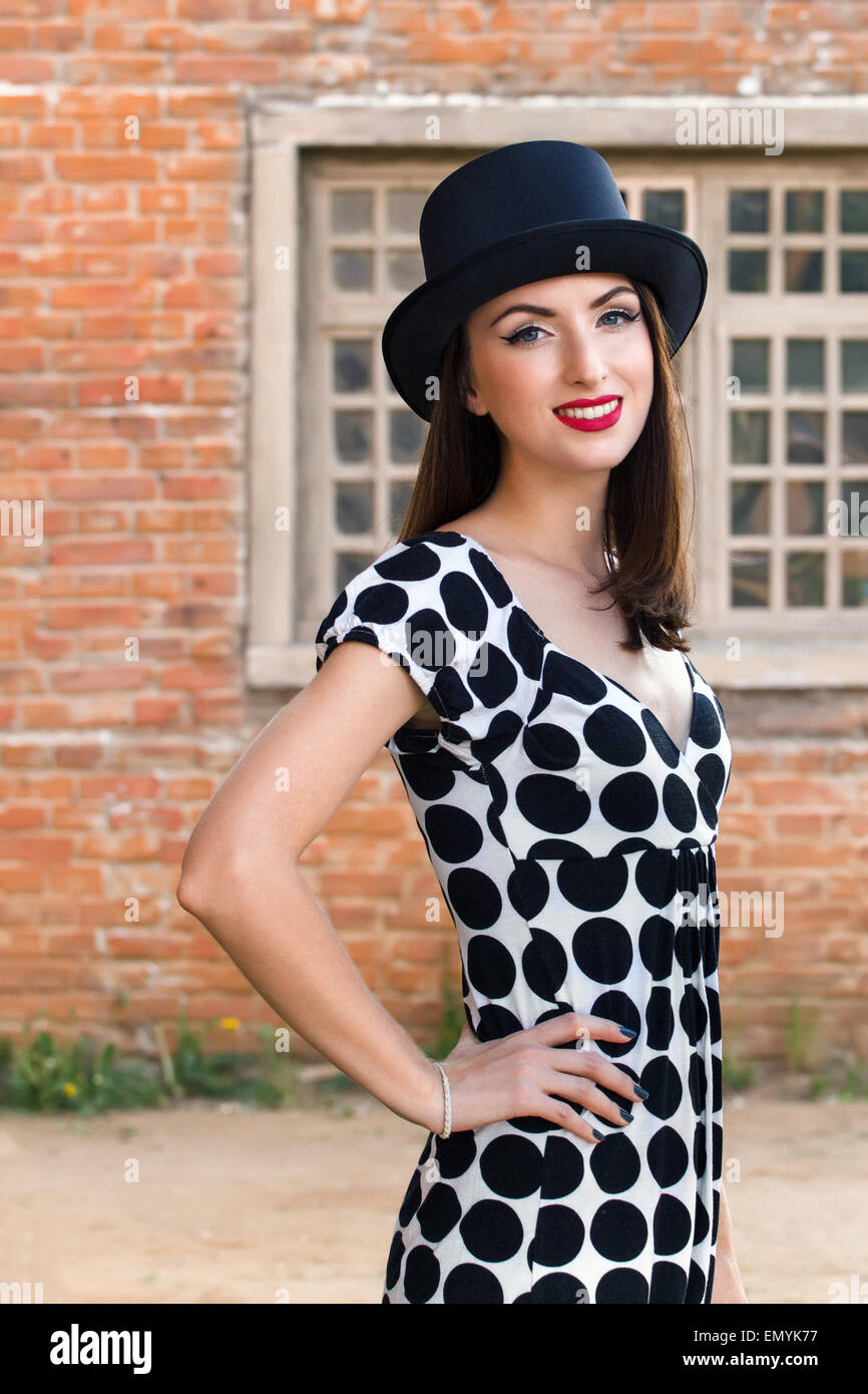 Happy young woman wearing top hat Stock Photo - Alamy