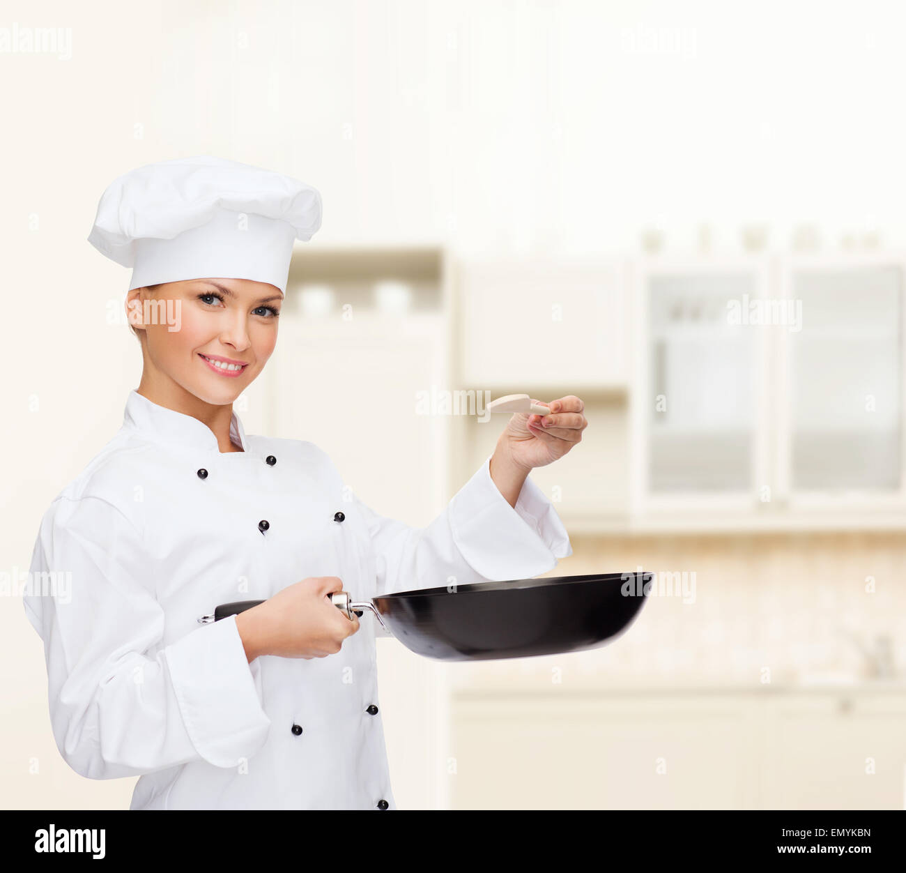 smiling female chef with pan and spoon Stock Photo - Alamy