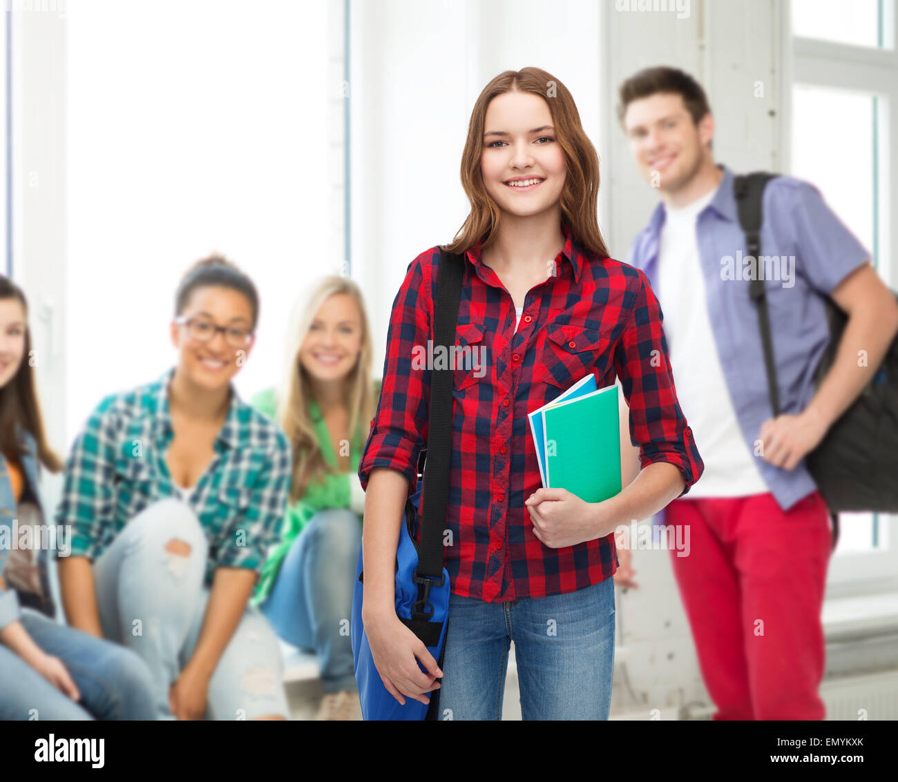 smiling female student with bag and notebooks Stock Photo - Alamy
