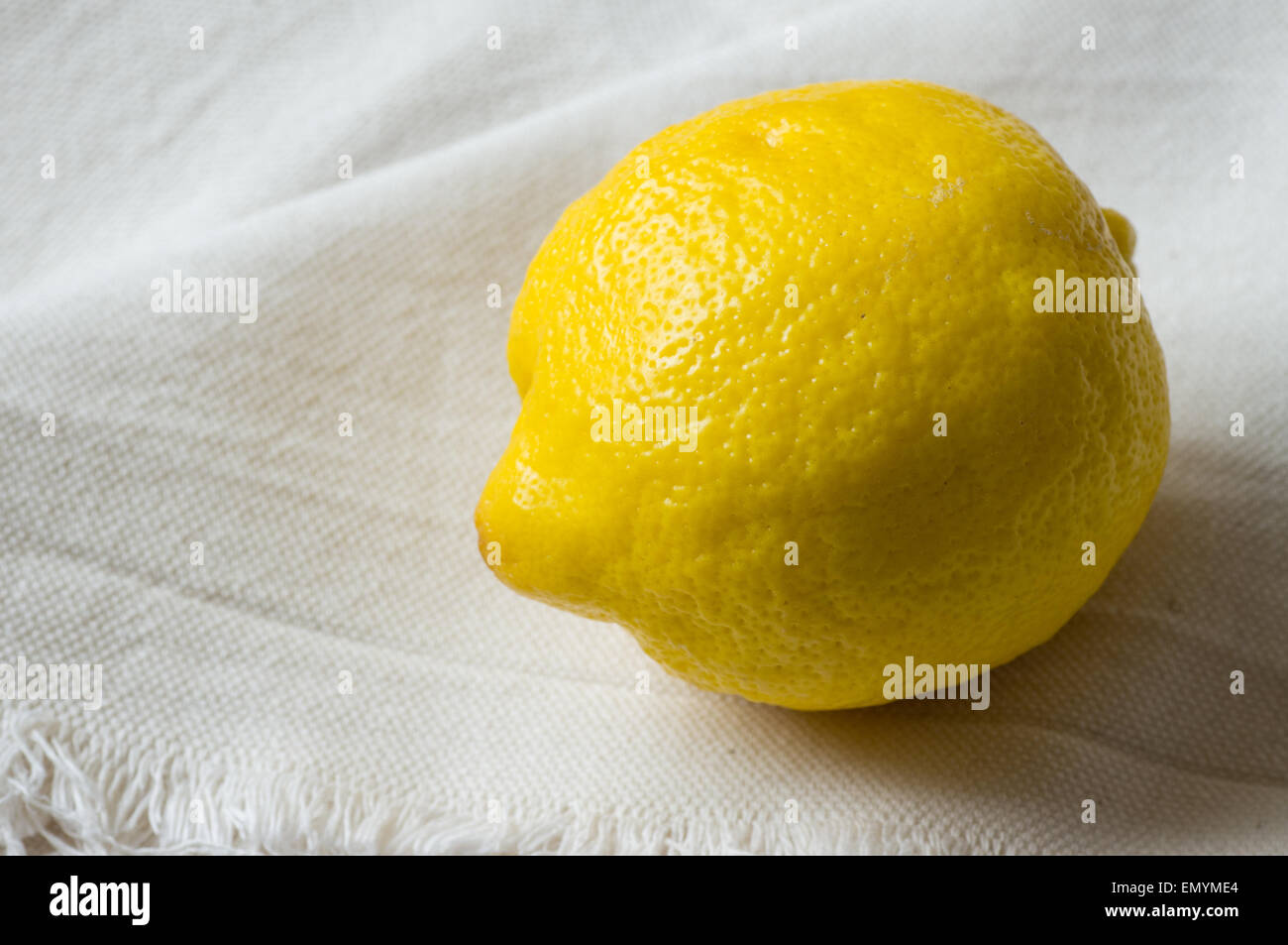 Large ripe fresh yellow lemon on a rough fabric Stock Photo - Alamy