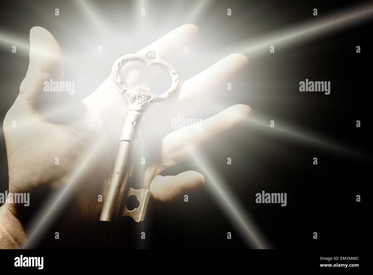 Human hand with an old key Stock Photo - Alamy