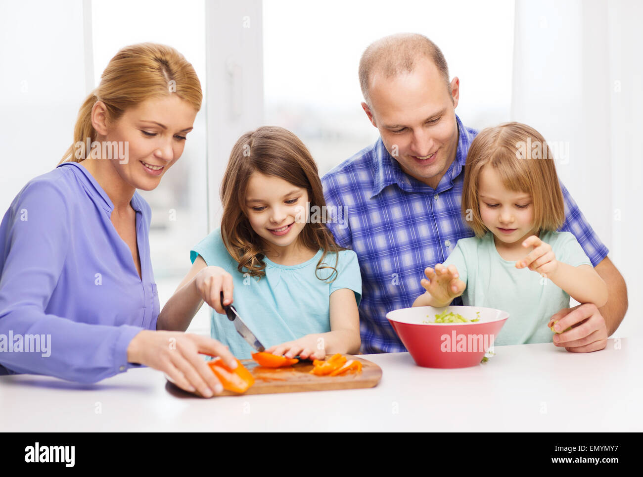 happy family with two kids making dinner at home Stock Photo - Alamy