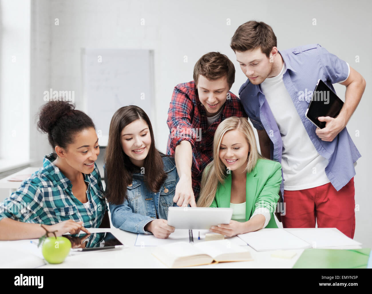 students looking at tablet pc at school Stock Photo - Alamy