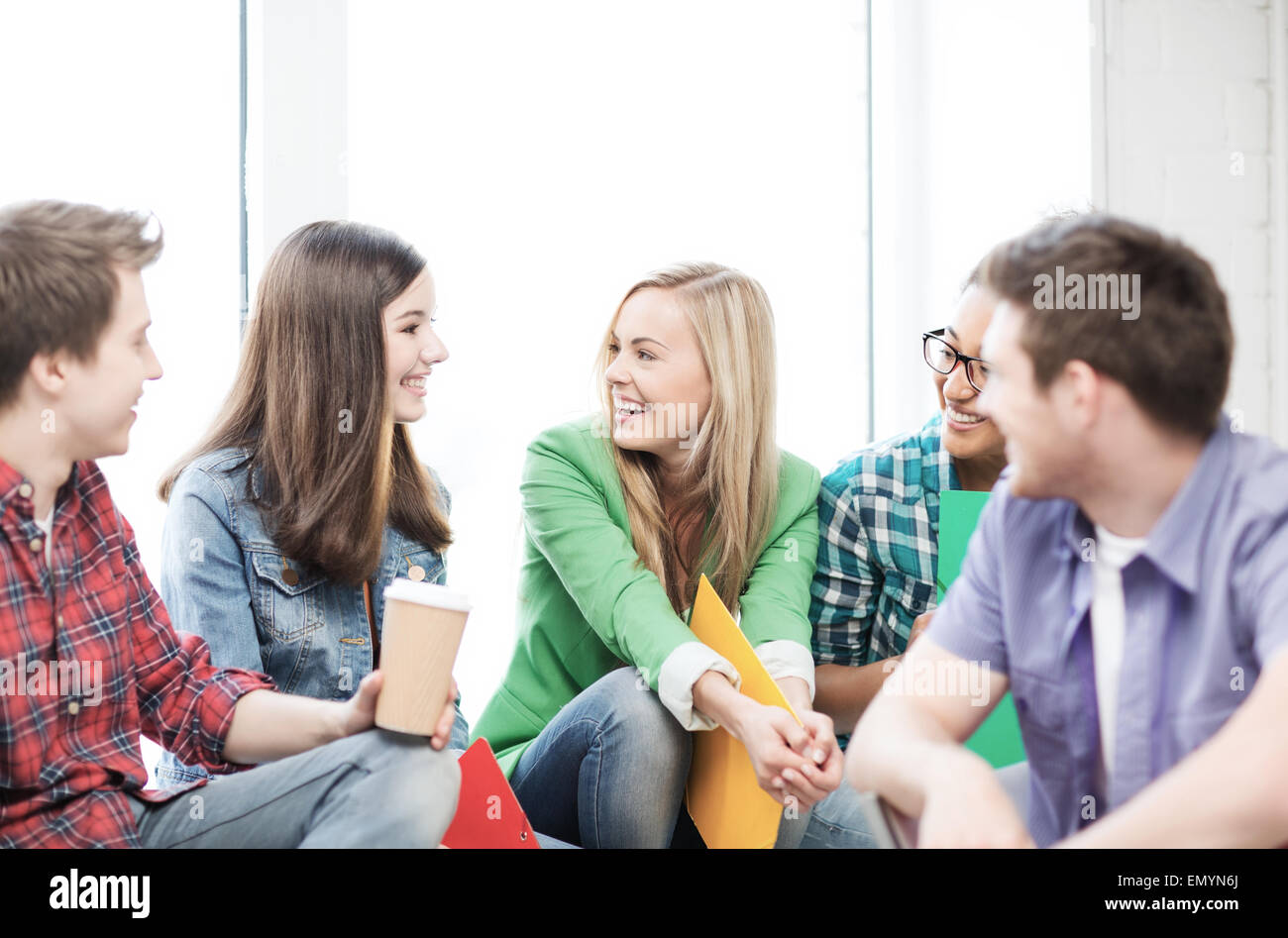 students communicating and laughing at school Stock Photo - Alamy