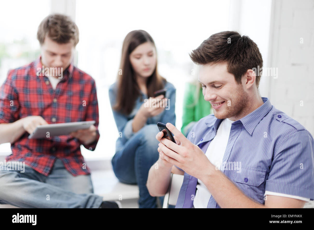 student looking into smartphone at school Stock Photo - Alamy