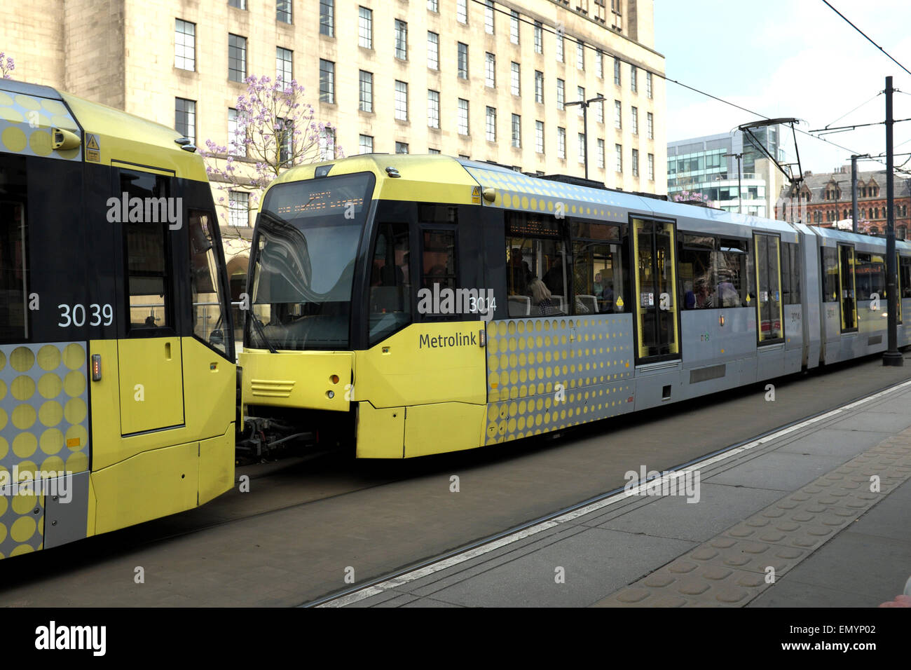a double tram arrives at st peter's square tram station in manchester ...