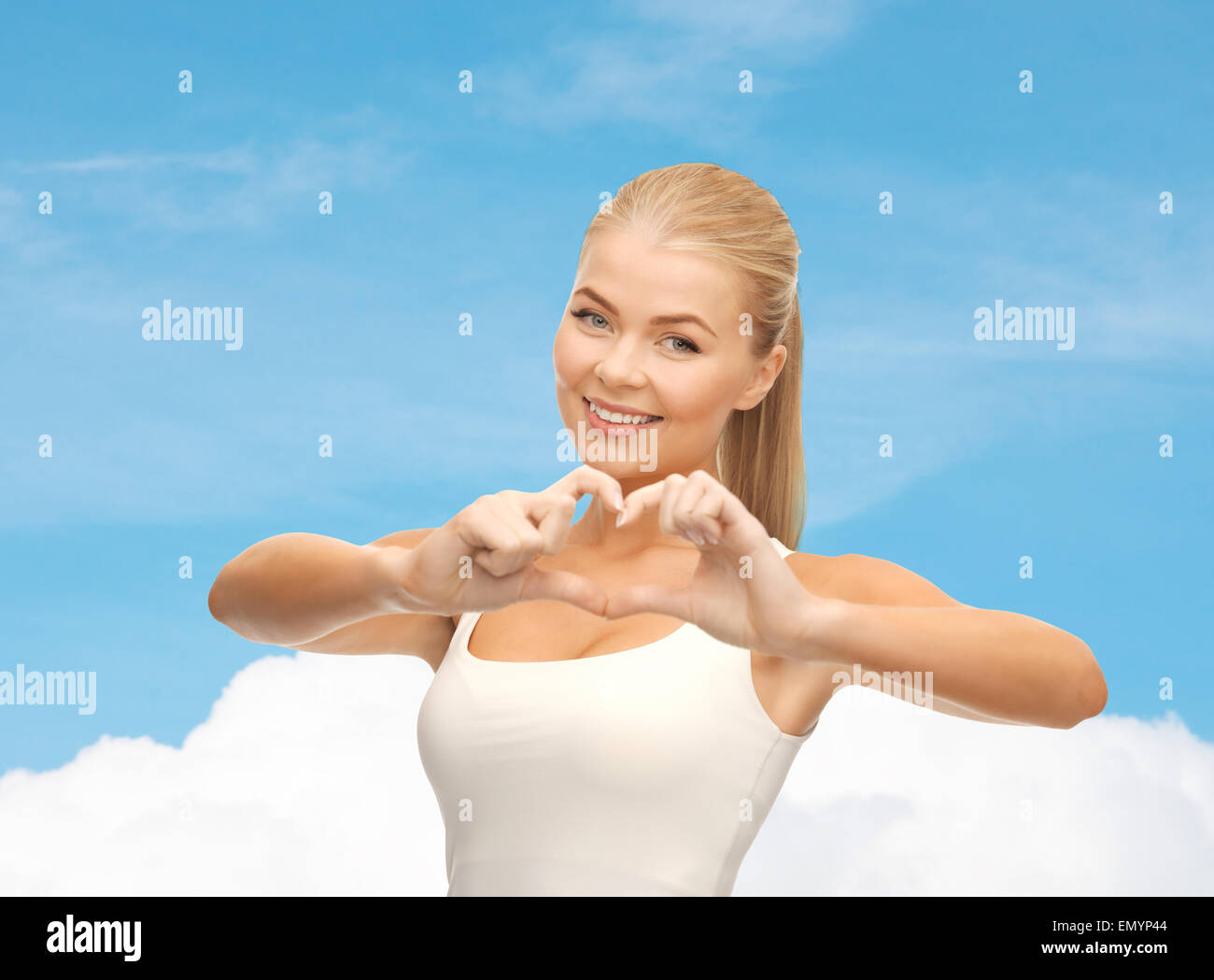 smiling woman showing heart shape gesture Stock Photo - Alamy
