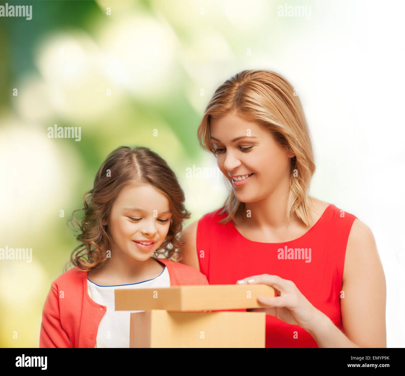 smiling mother and daughter opening gift box Stock Photo - Alamy
