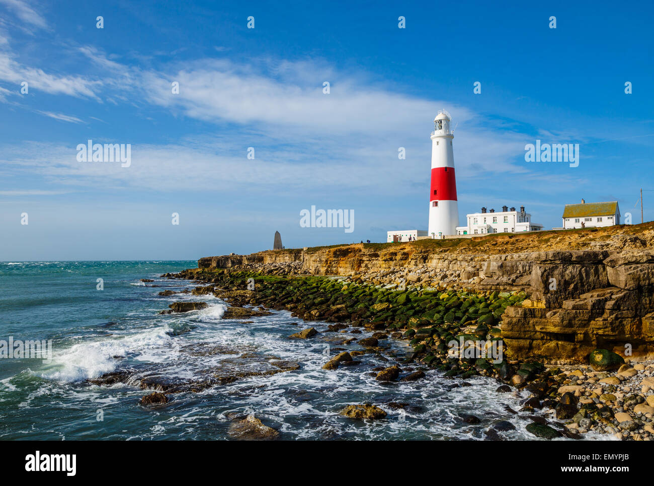 The active lighthouse and sea shore at Portland Bill, Dorset on a sunny ...