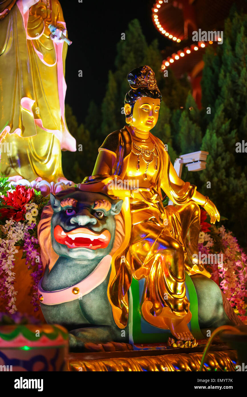 Buddha statues decorated with beautiful flower and led lights at a ...