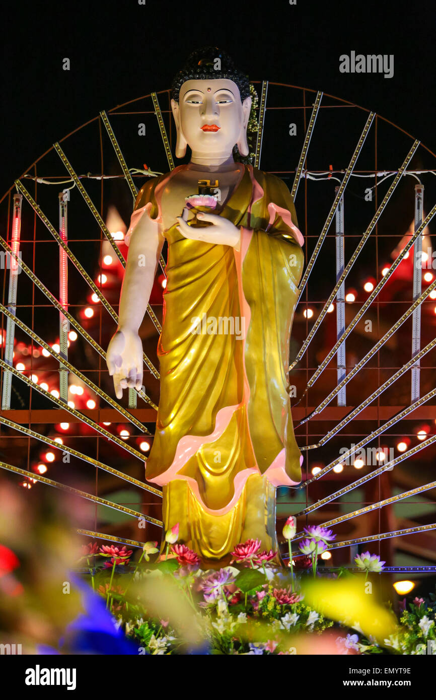 Buddha statues decorated with beautiful flower and led lights at a ...