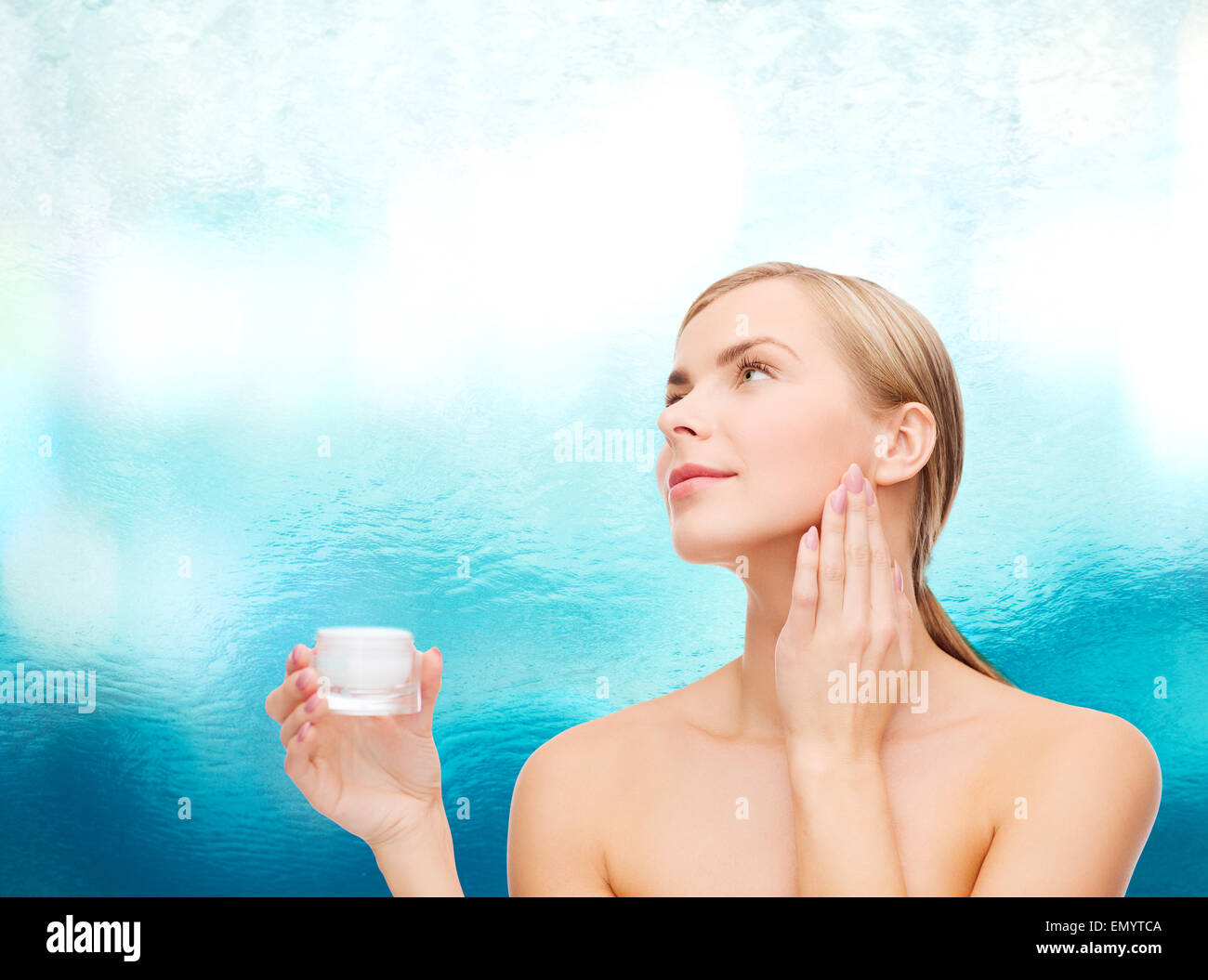 woman applying cream on her skin Stock Photo - Alamy
