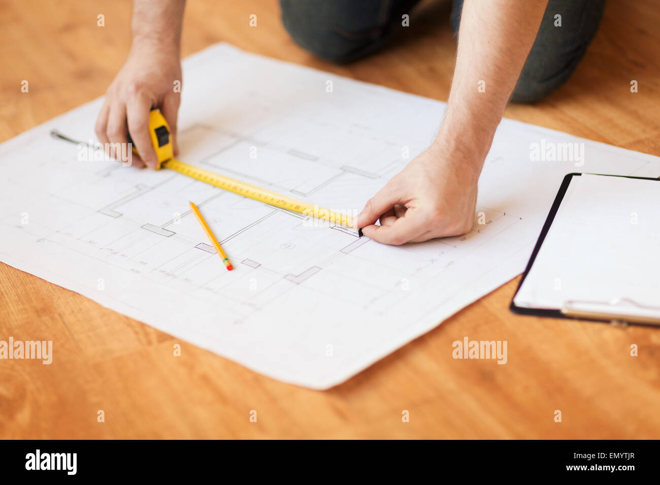 close up of male hands measuring blueprint Stock Photo - Alamy
