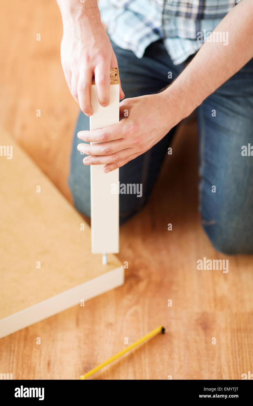 close up of male hands assemblying legs to table Stock Photo - Alamy