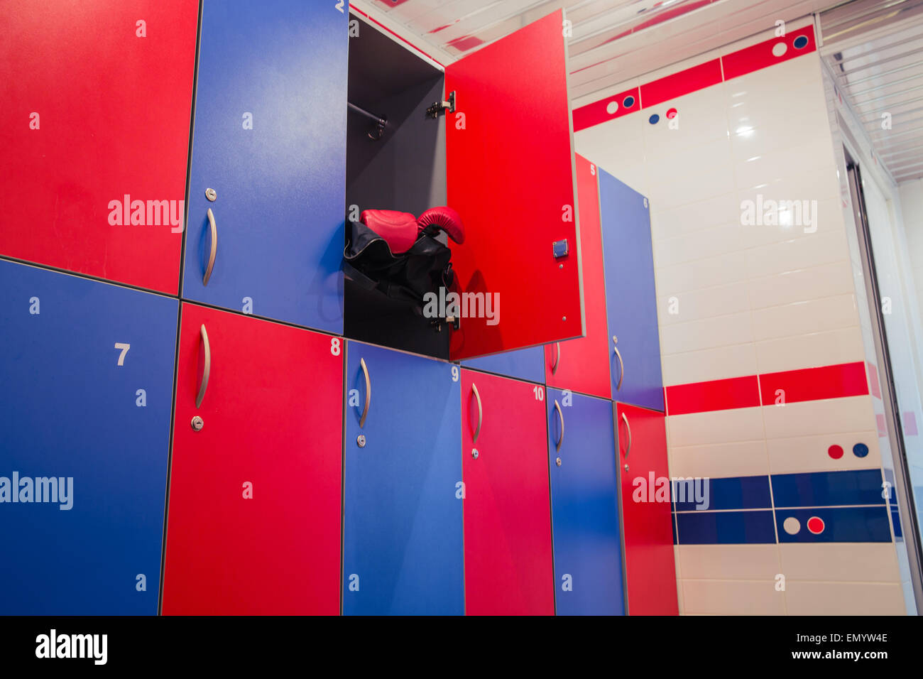 Closeup image of a bag with boxing gloves in locker room Stock Photo ...