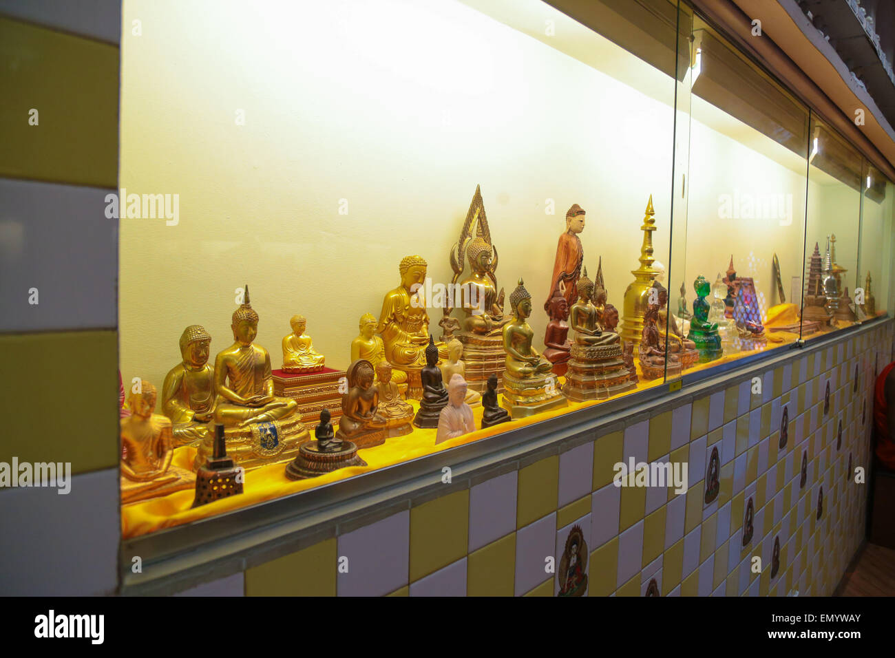 Various buddha statues encased inside a display cabinet at Buddhist ...