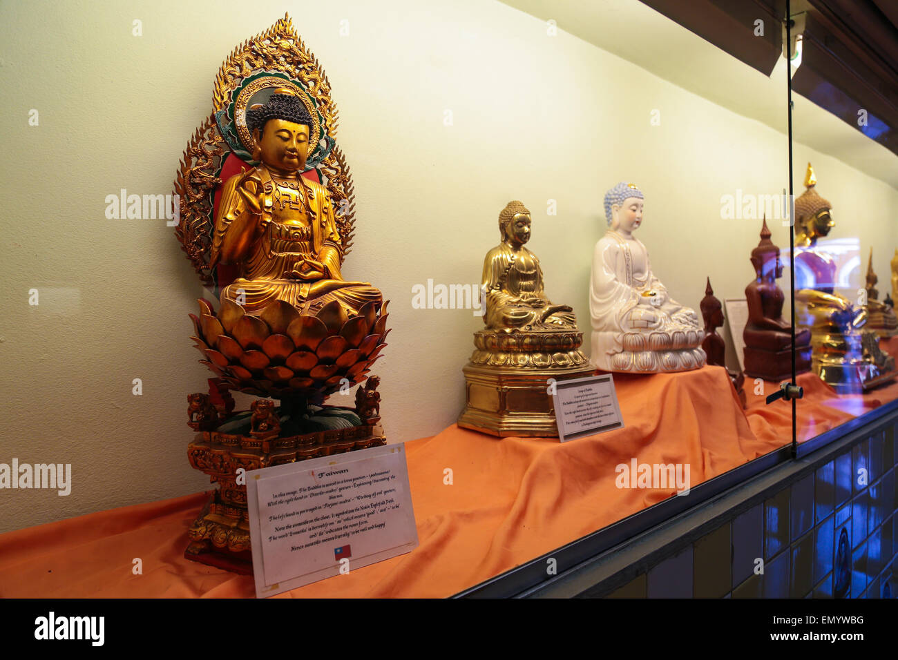Various buddha statues encased inside a display cabinet at Buddhist ...