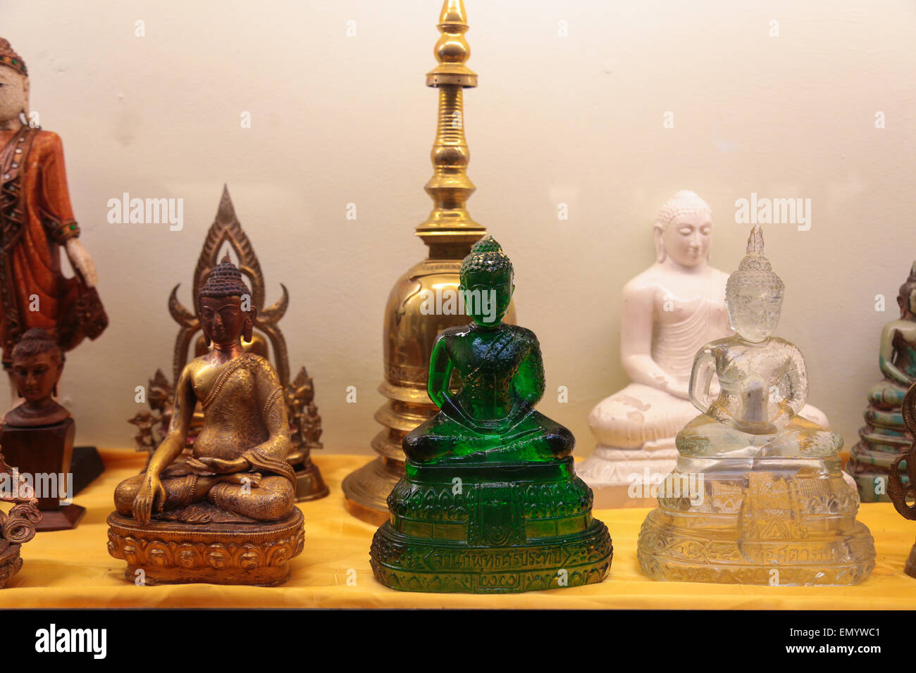 Various sitting buddha statues inside a display cabinet at Buddhist ...
