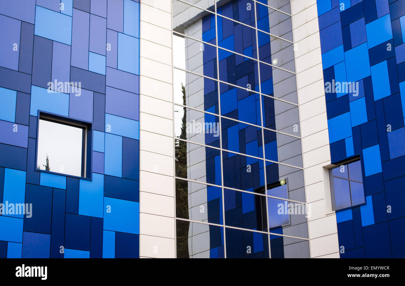 Modern style blue and white building with reflective glass windows ...