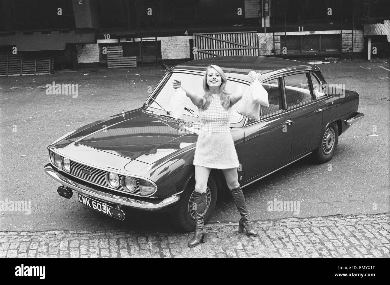 Reveille model seen here posing with a Triumph 2000 which is top prize ...