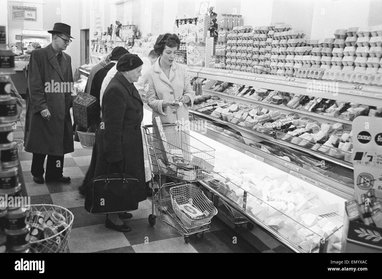 Shoppers browsing the dairy counter at a newly opened self service food ...
