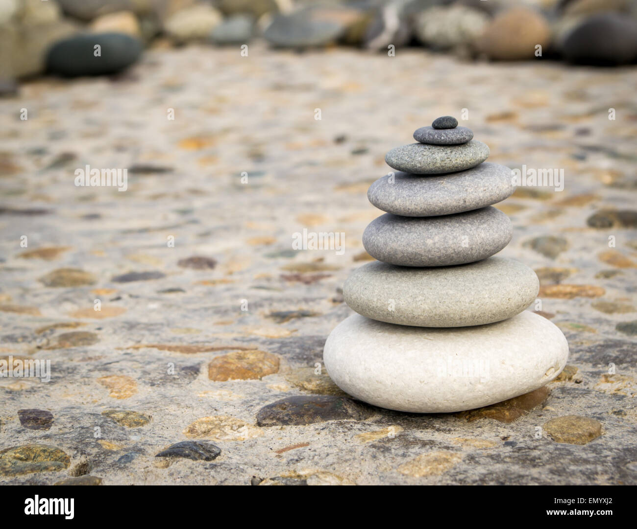 Balancing stones on a rough stone background Stock Photo - Alamy