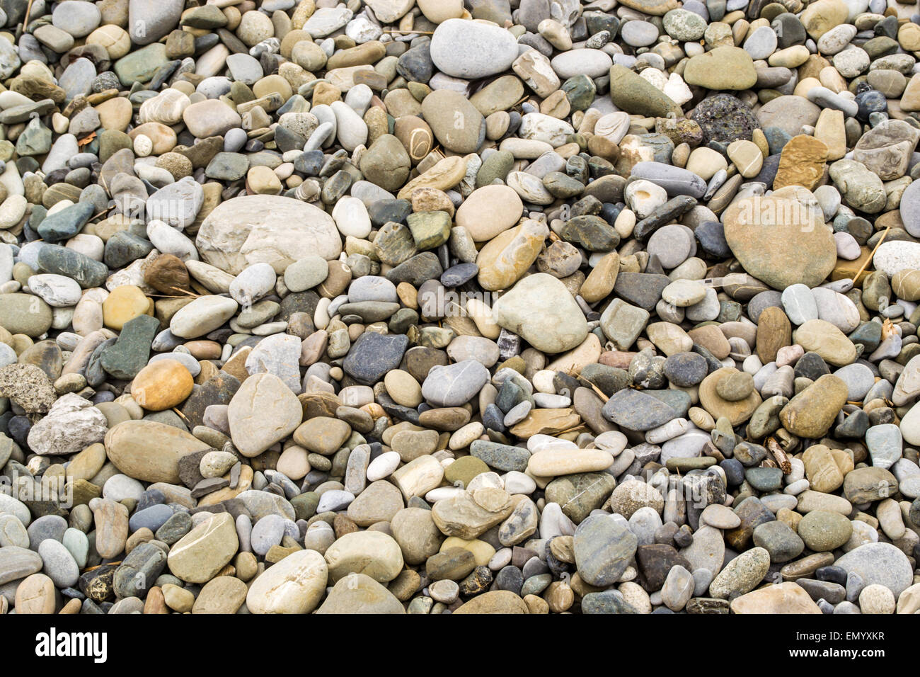 Patterns formed by random stones and bebbles on the beach Stock Photo ...