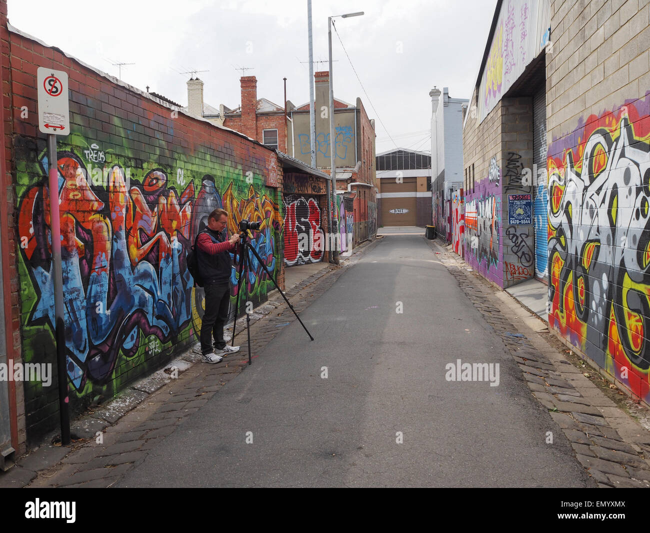 Alley with graffiti on walls Stock Photo - Alamy