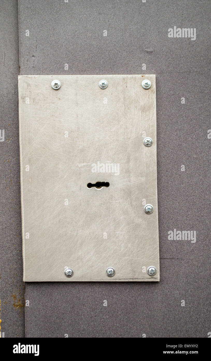 Silver door lock with rivets and grey painted metal surrounds Stock ...