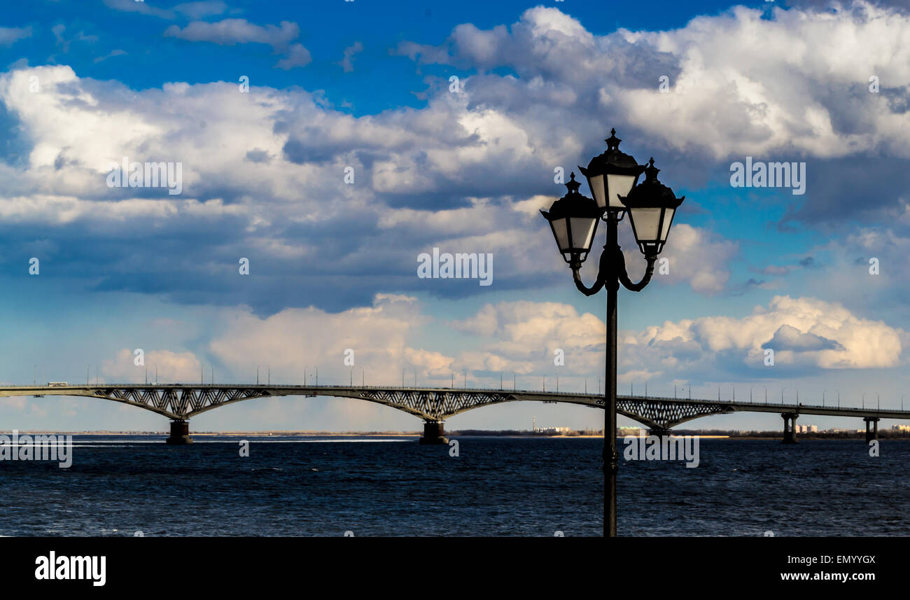A single cast iron lampost with a large bridge in the background Stock ...