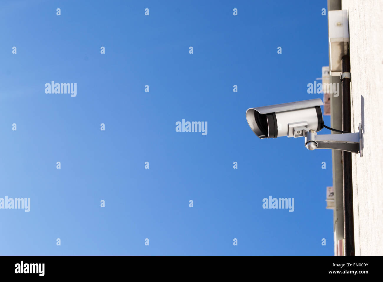 A CCTV camera attached to a residential housing wall Stock Photo - Alamy