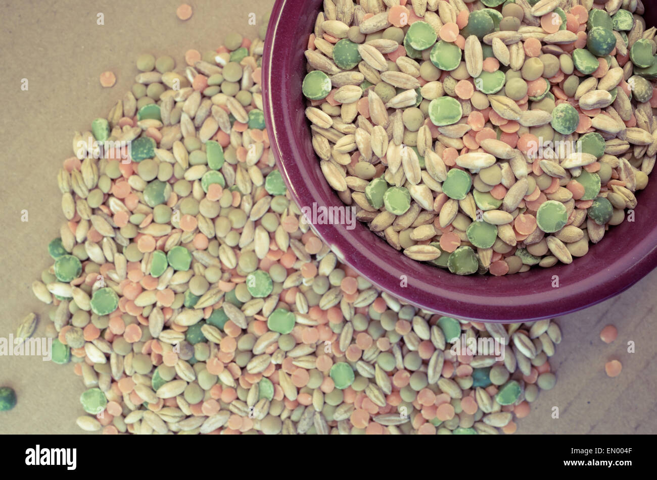 dried split mixed grains in a brown porcelain cup and on a paperboard ...