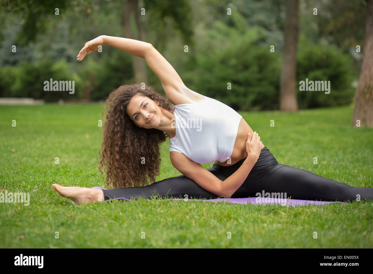 Pretty woman doing yoga exercises Stock Photo - Alamy