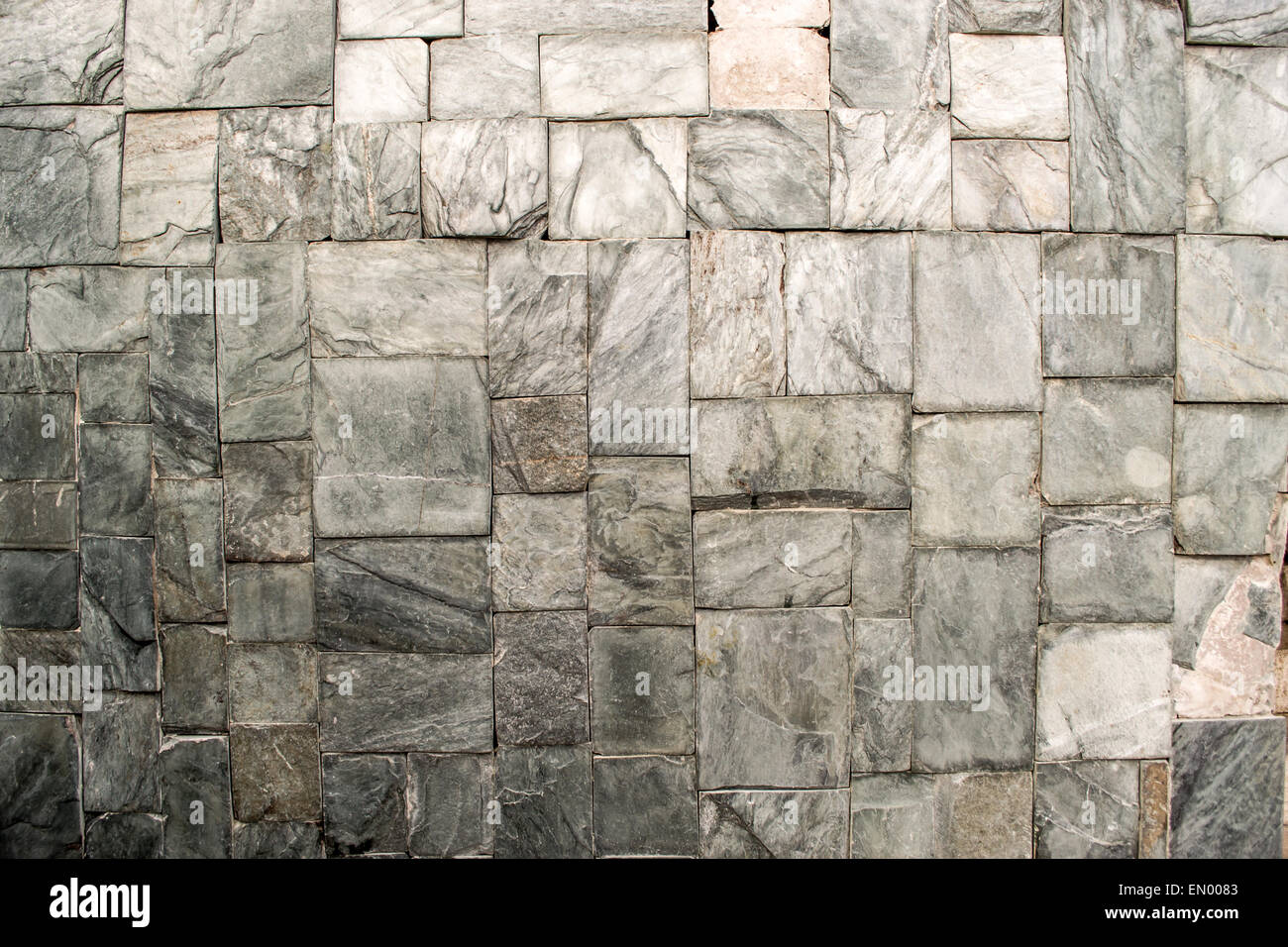 Perfectly aligned stones create a rock wall construction in grey Stock ...