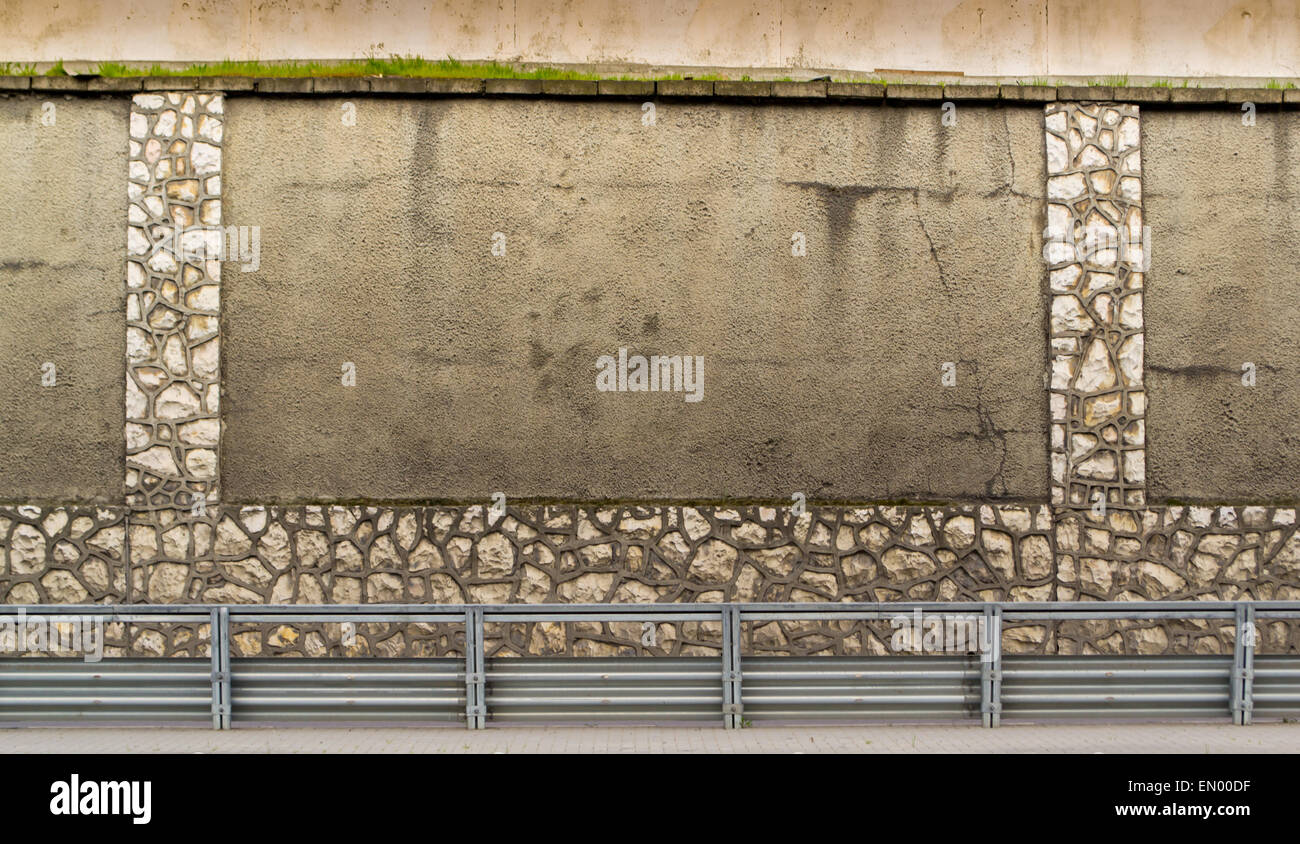 Stone blocks create a strong cement wall with a metal railing Stock ...