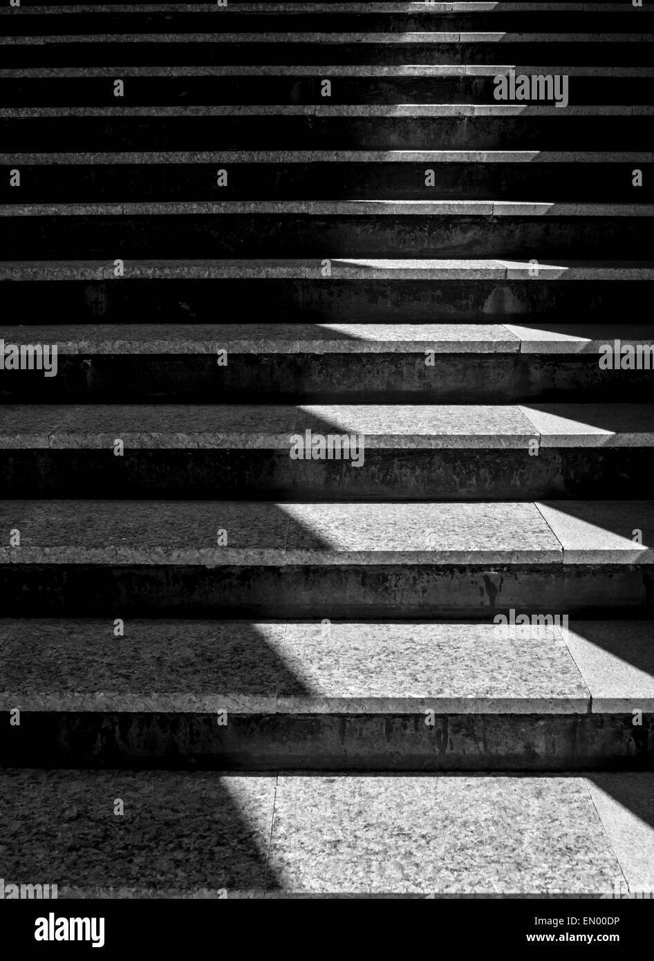 Sun shines onto steps creating areas of high contrast in black and ...