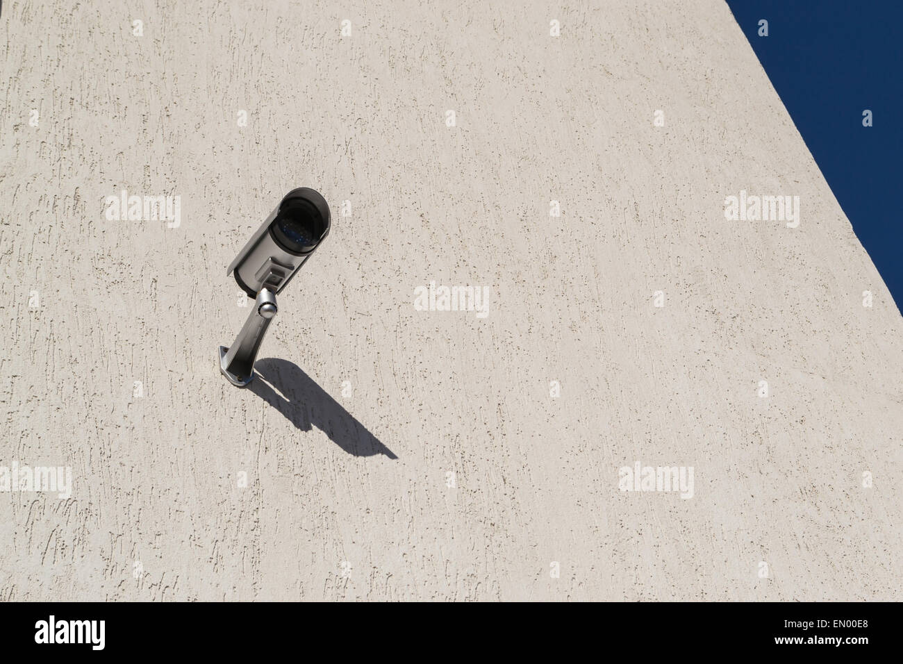 A CCTV camera attached to a white stone wall Stock Photo - Alamy