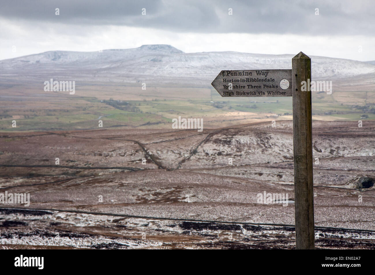 A Pennine Way sign on Pen-y-ghent, with Inglebrough in the distance ...