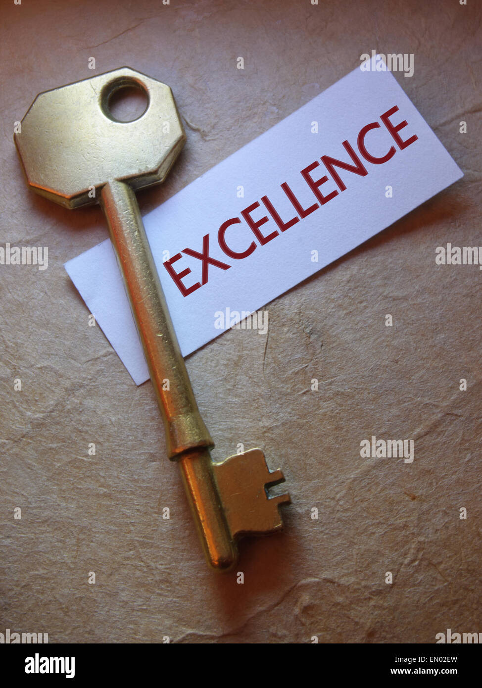 Close up of a golden key with excellence label Stock Photo - Alamy