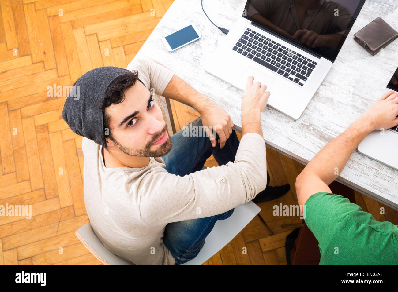 Two workmates teaming up and working together Stock Photo - Alamy