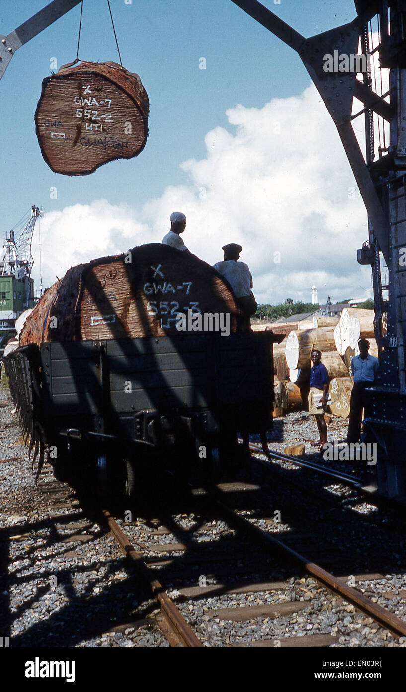 1960s, Ghana, log pond at Takoradi harbour. Loading logs at railhead ...