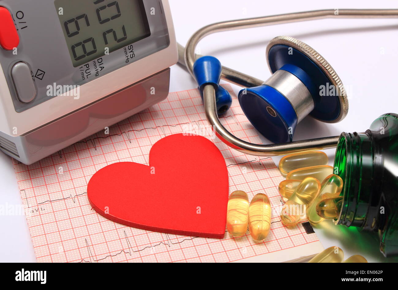 Red heart shape on electrocardiogram graph, medical stethoscope ...