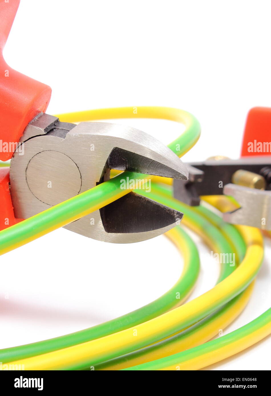 Metal pliers with tangled green-yellow electric cable, pliers cut the ...