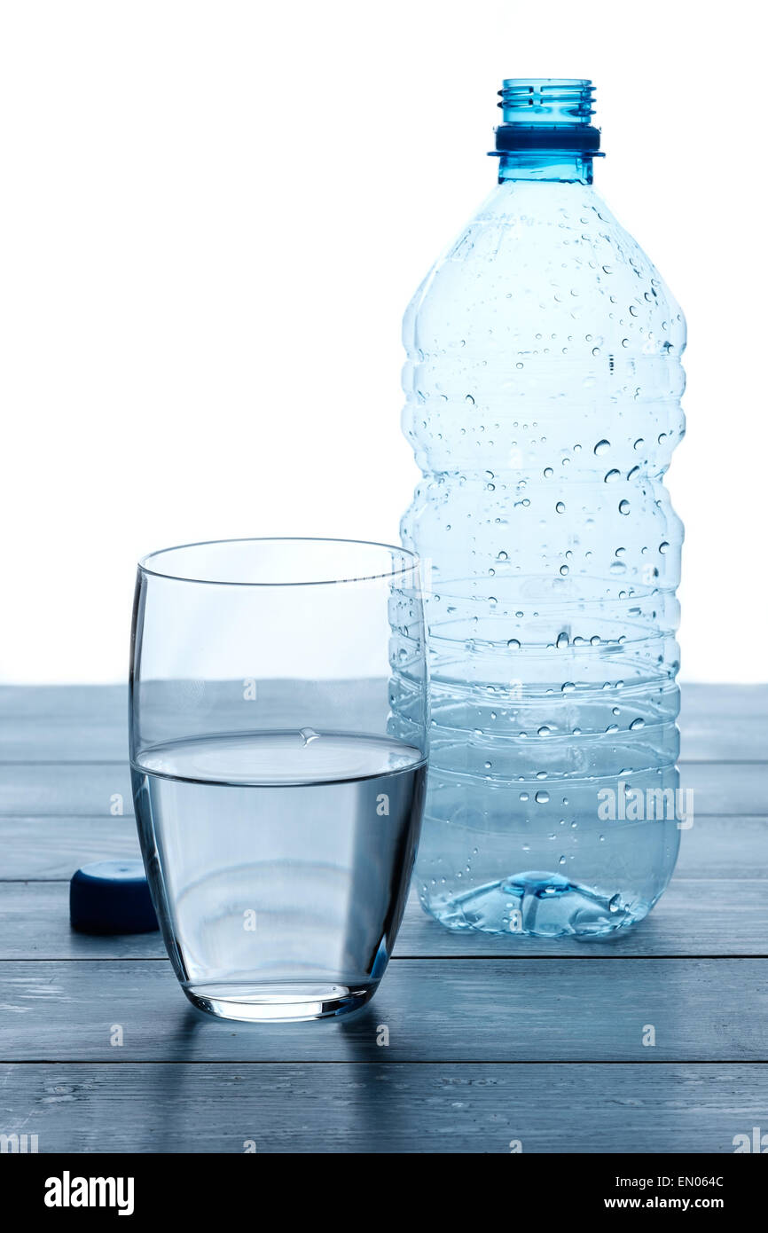 Empty bottles and glass of water on a wooden table Stock Photo - Alamy