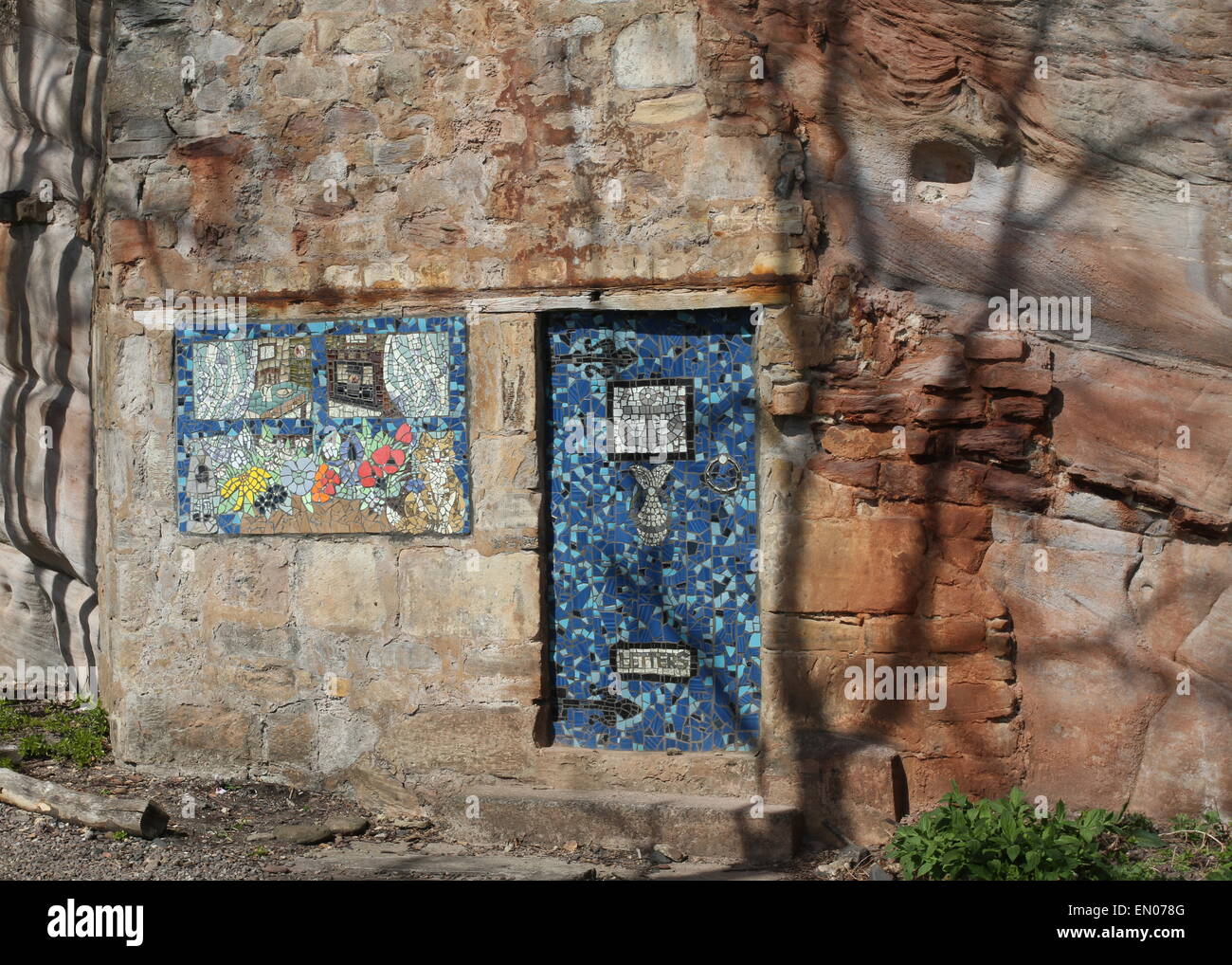 Door and window mosaic on cliff face West Wemyss Fife Scotland April ...