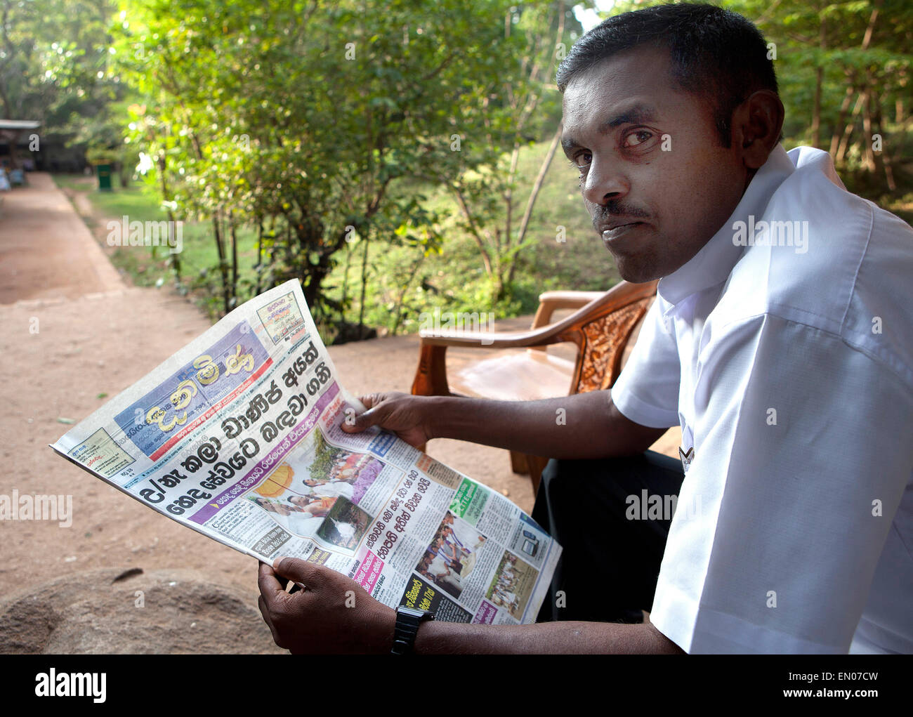 SRI LANKA: man reading local sinhalese newspaper Stock Photo - Alamy