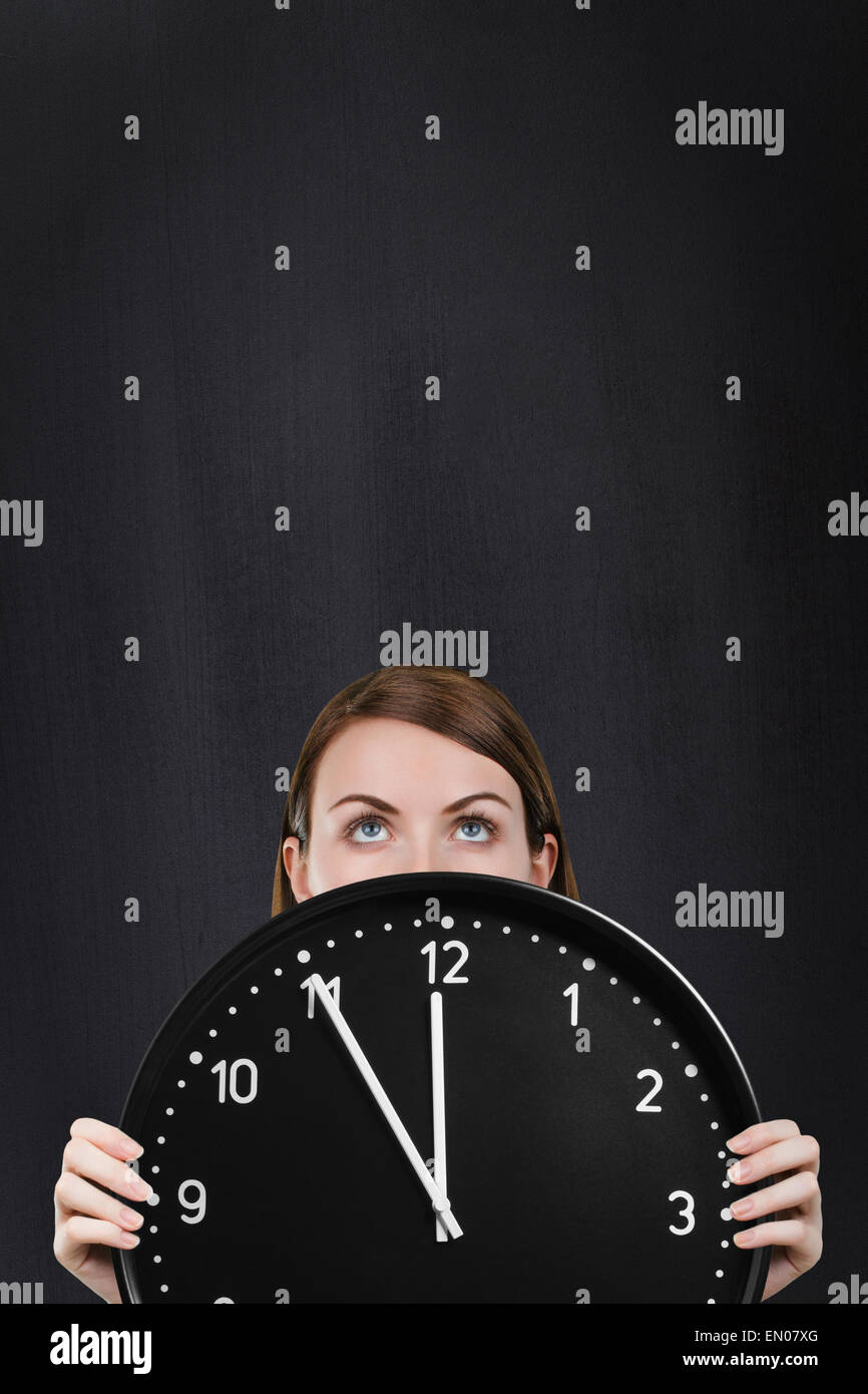 Woman face with a big clock Stock Photo - Alamy