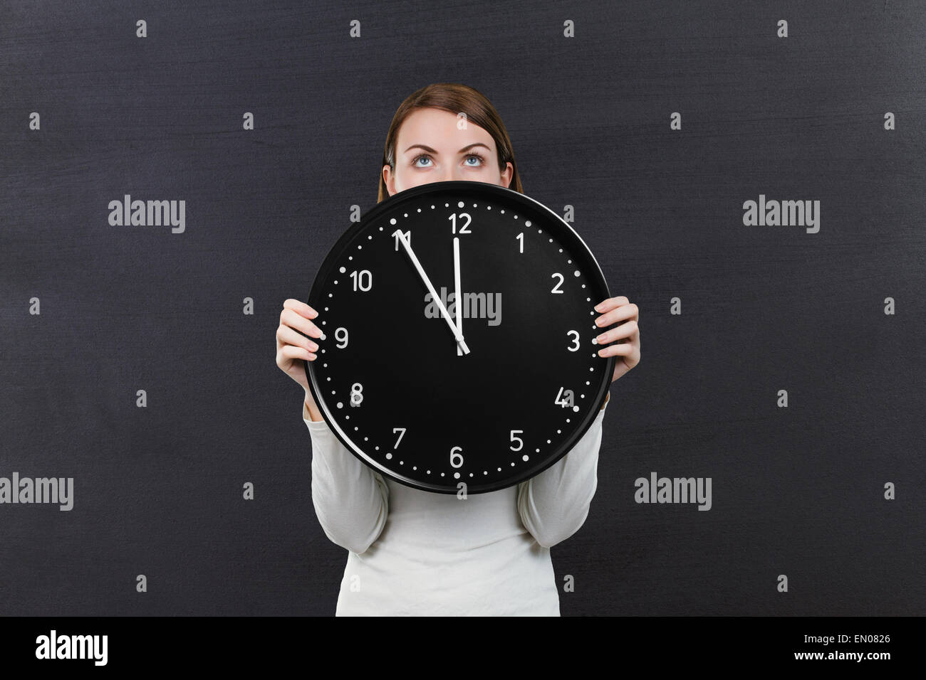 Woman face with a big clock Stock Photo - Alamy