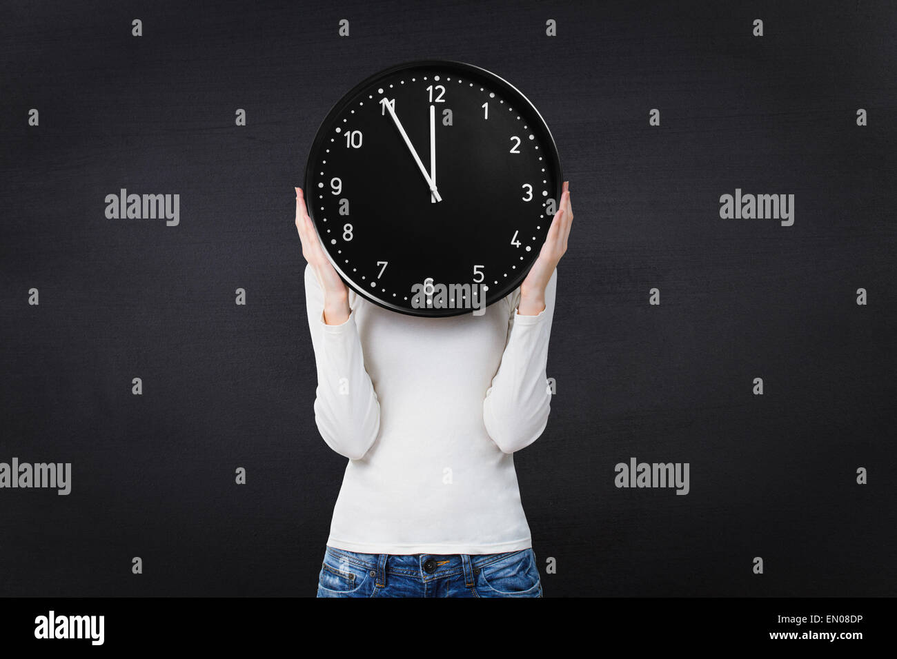 Woman holding clock over face hi-res stock photography and images - Alamy