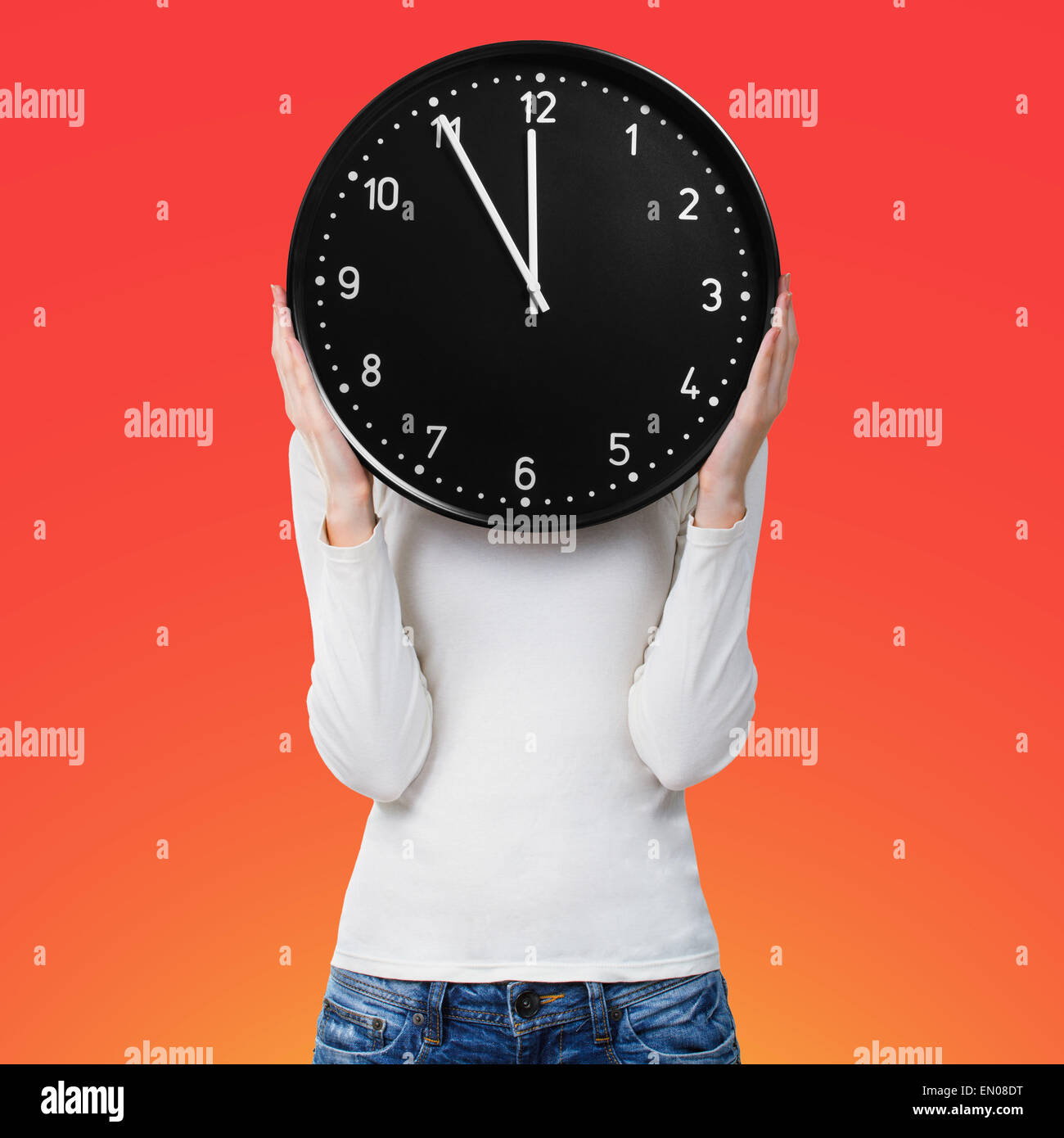 Woman holding clock over face hi-res stock photography and images - Alamy